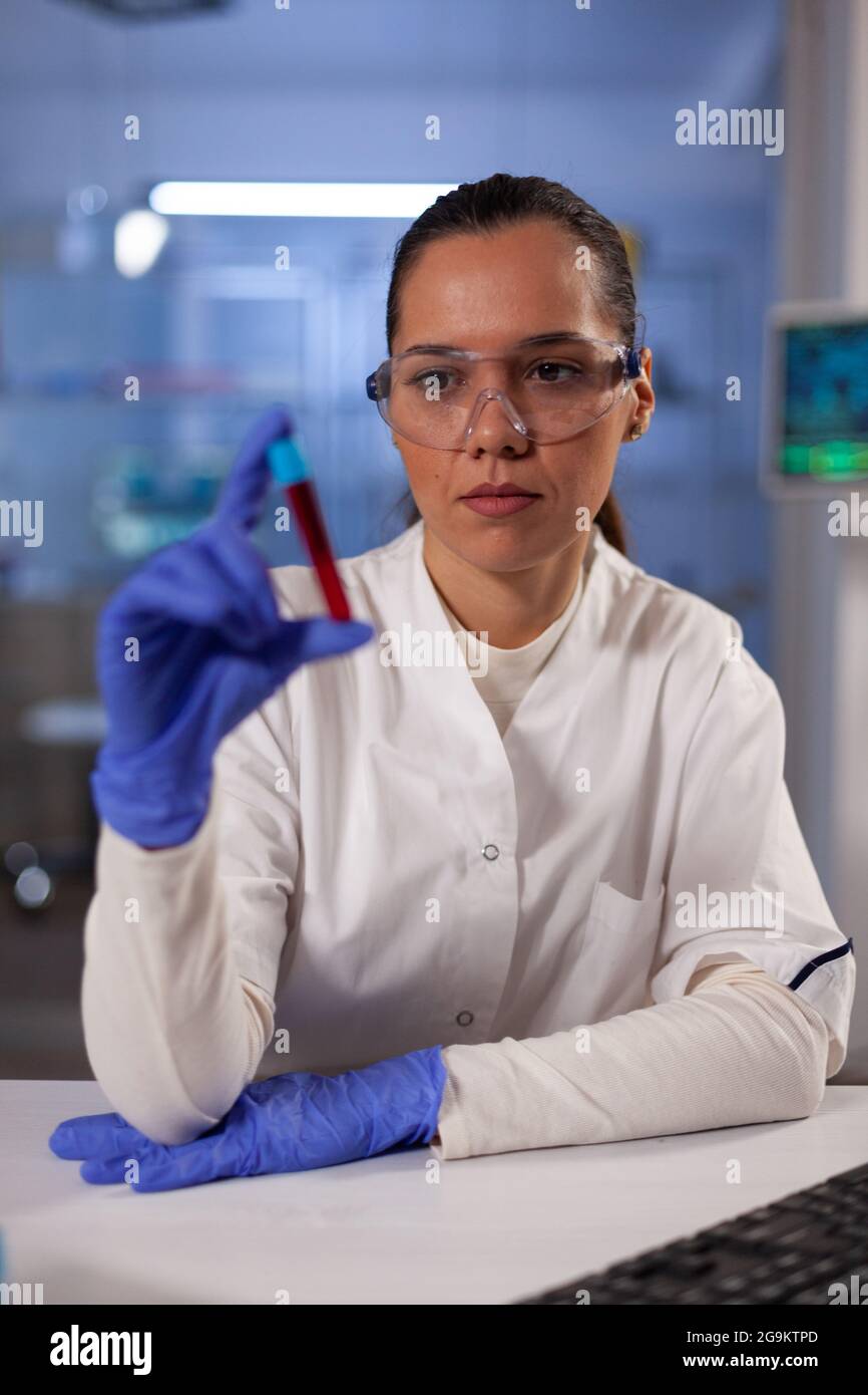 Scientific research doctor holding test tube with blood for modern ...