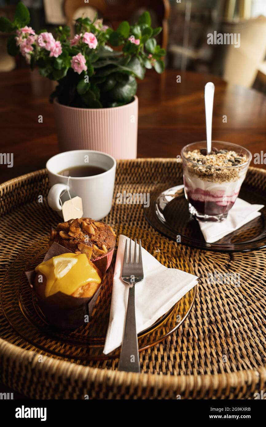 Simple breakfast of tea cup muffins and muesli yoghurt Stock Photo - Alamy