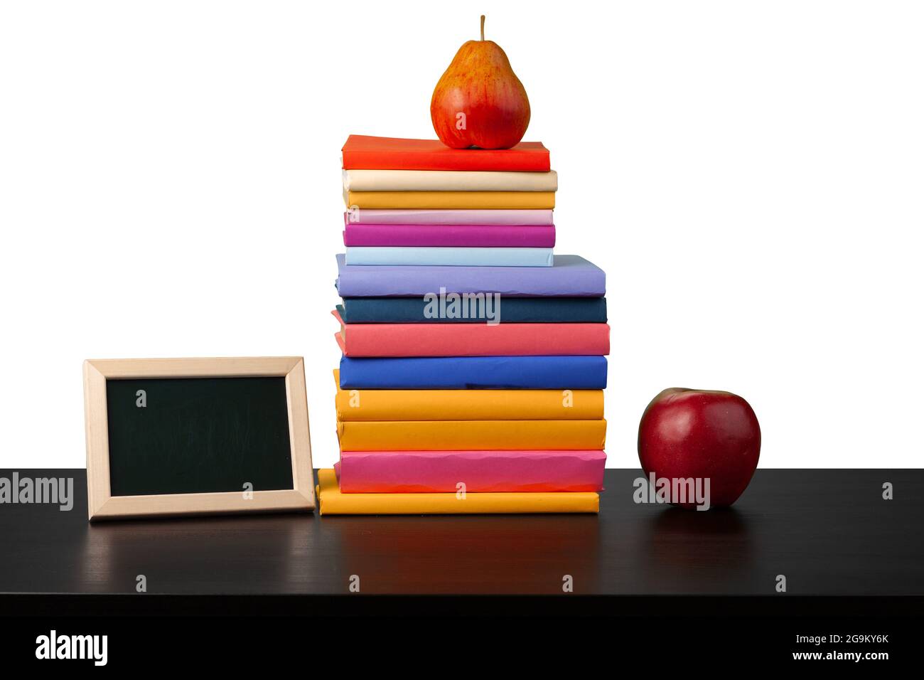 Stack of books and apple on tabletop against white background Stock ...