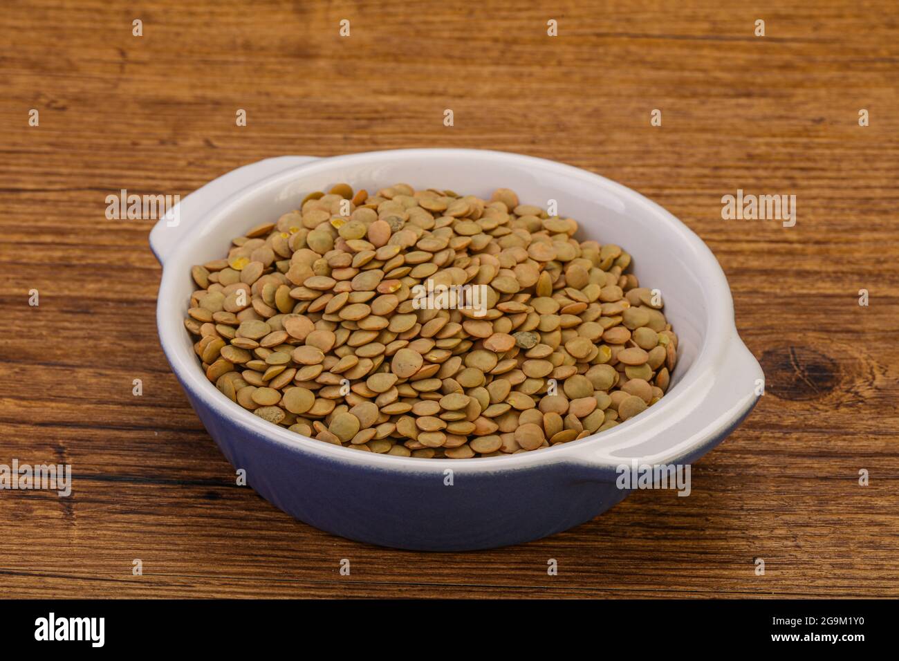 Vegan cuisine - Dry lentil heap isolated Stock Photo - Alamy