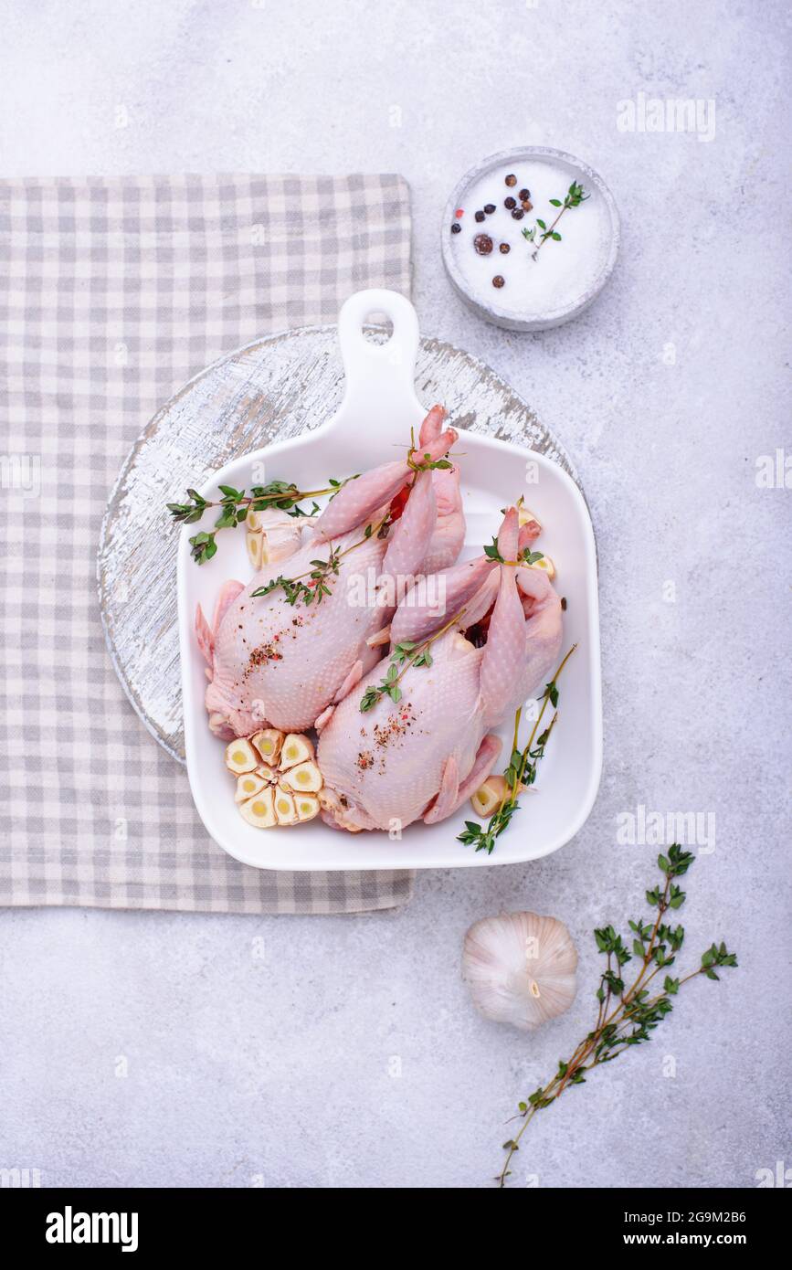 Raw quail meat with spices, garlic and herbs Stock Photo - Alamy