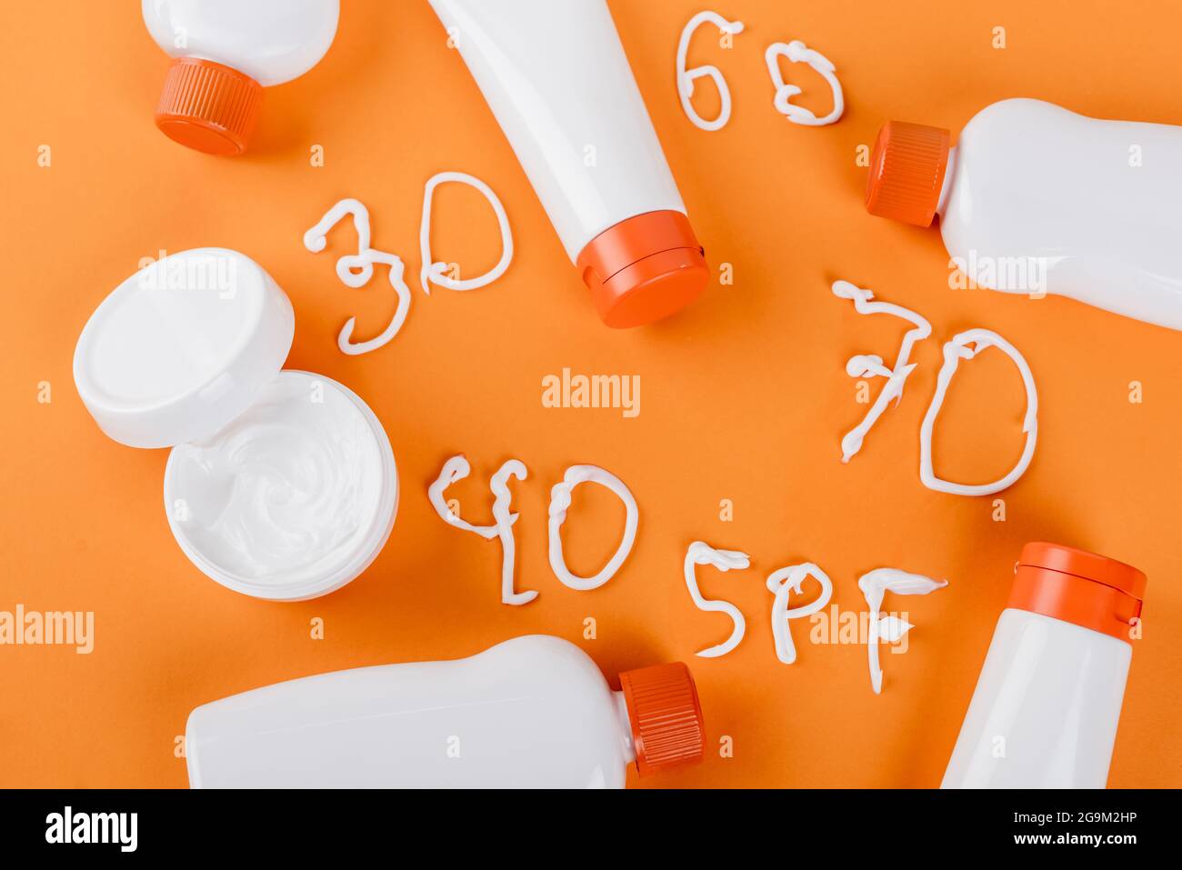 top view of sunscreen and cosmetic cream near different numbers and spf ...