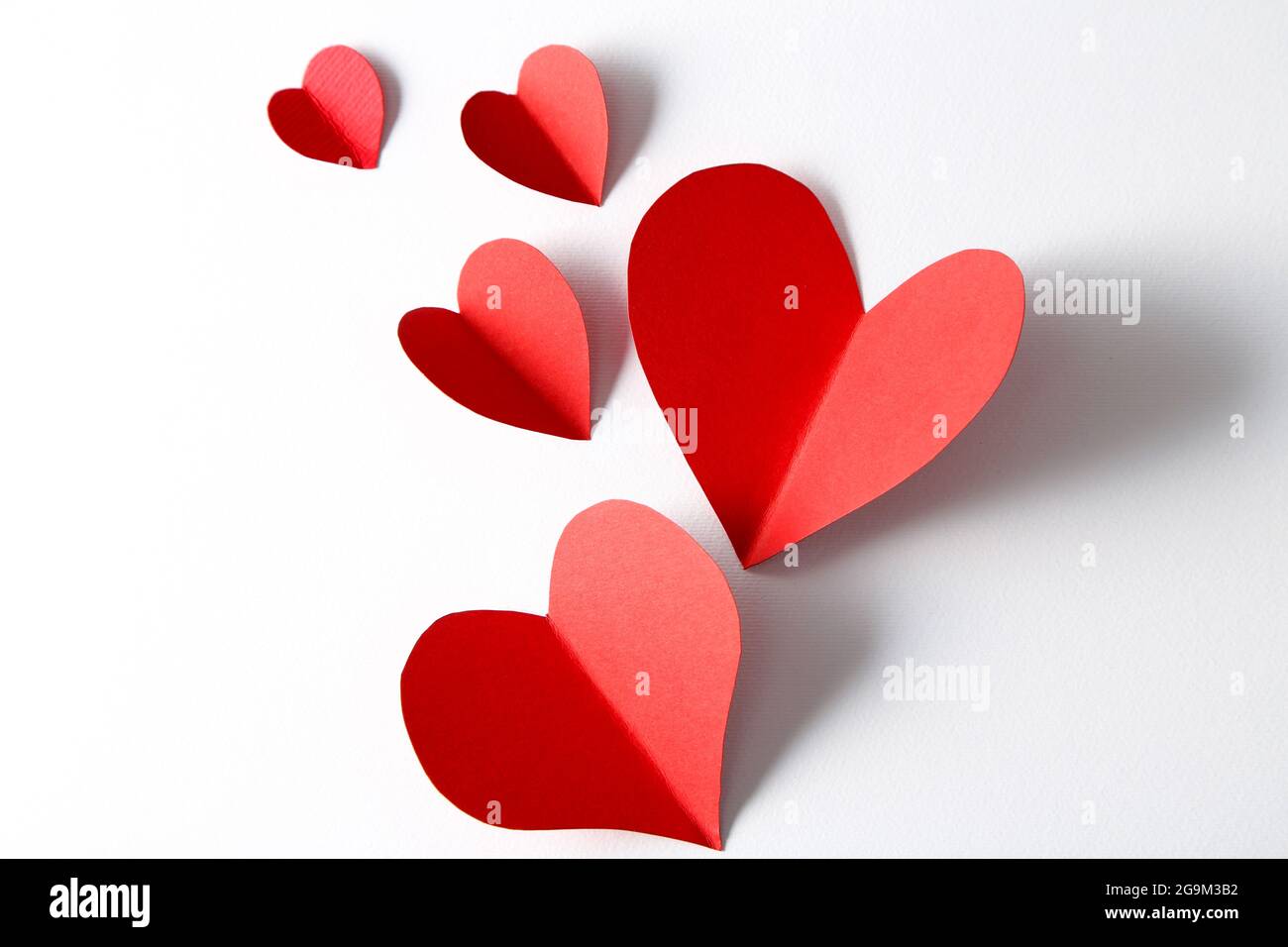 Beautiful paper hearts on white paper background, close-up Stock Photo ...