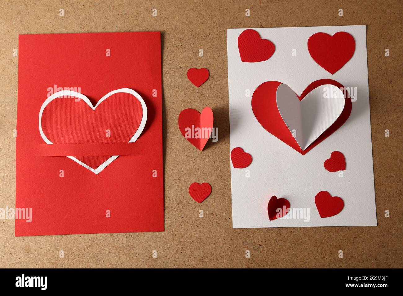 Beautiful hand made post cards with paper hearts on color wooden ...
