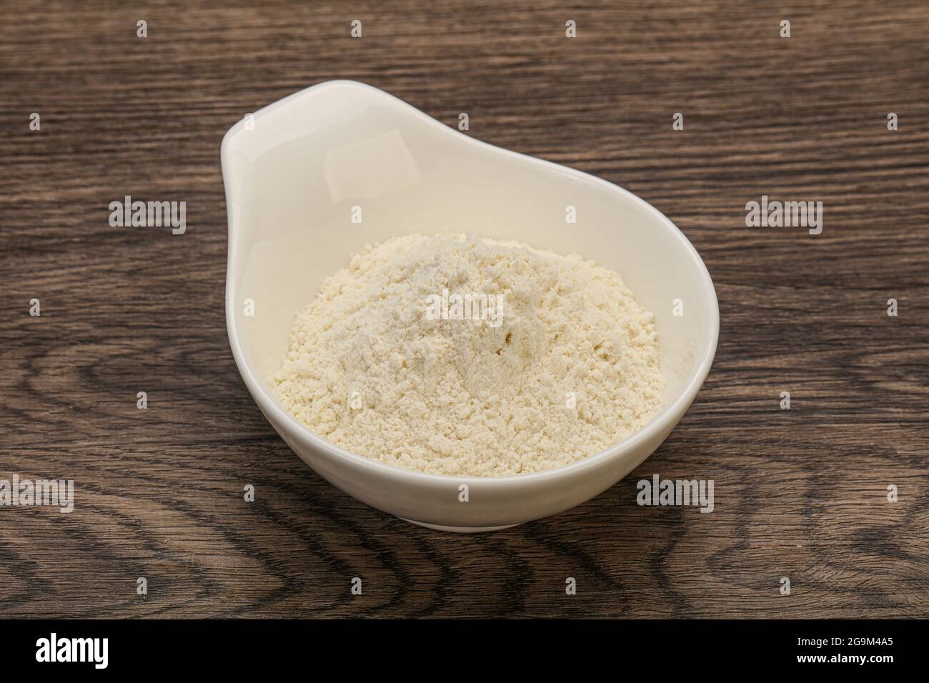 Wheat flour heap in the bowl for cooking Stock Photo - Alamy