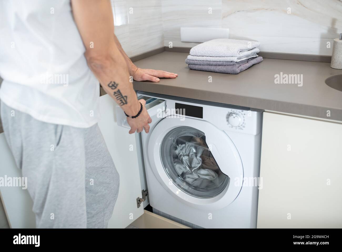 Close up picture of mans hands opening the washing machine Stock Photo ...