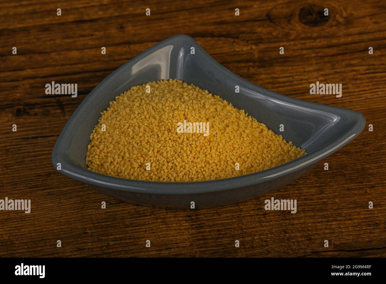 Raw cous cous heap in the bowl for cooking Stock Photo - Alamy