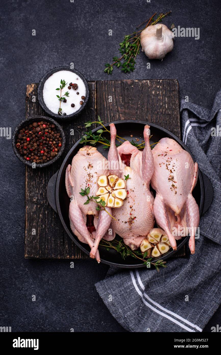 Raw quail meat with spices, garlic and herbs Stock Photo - Alamy