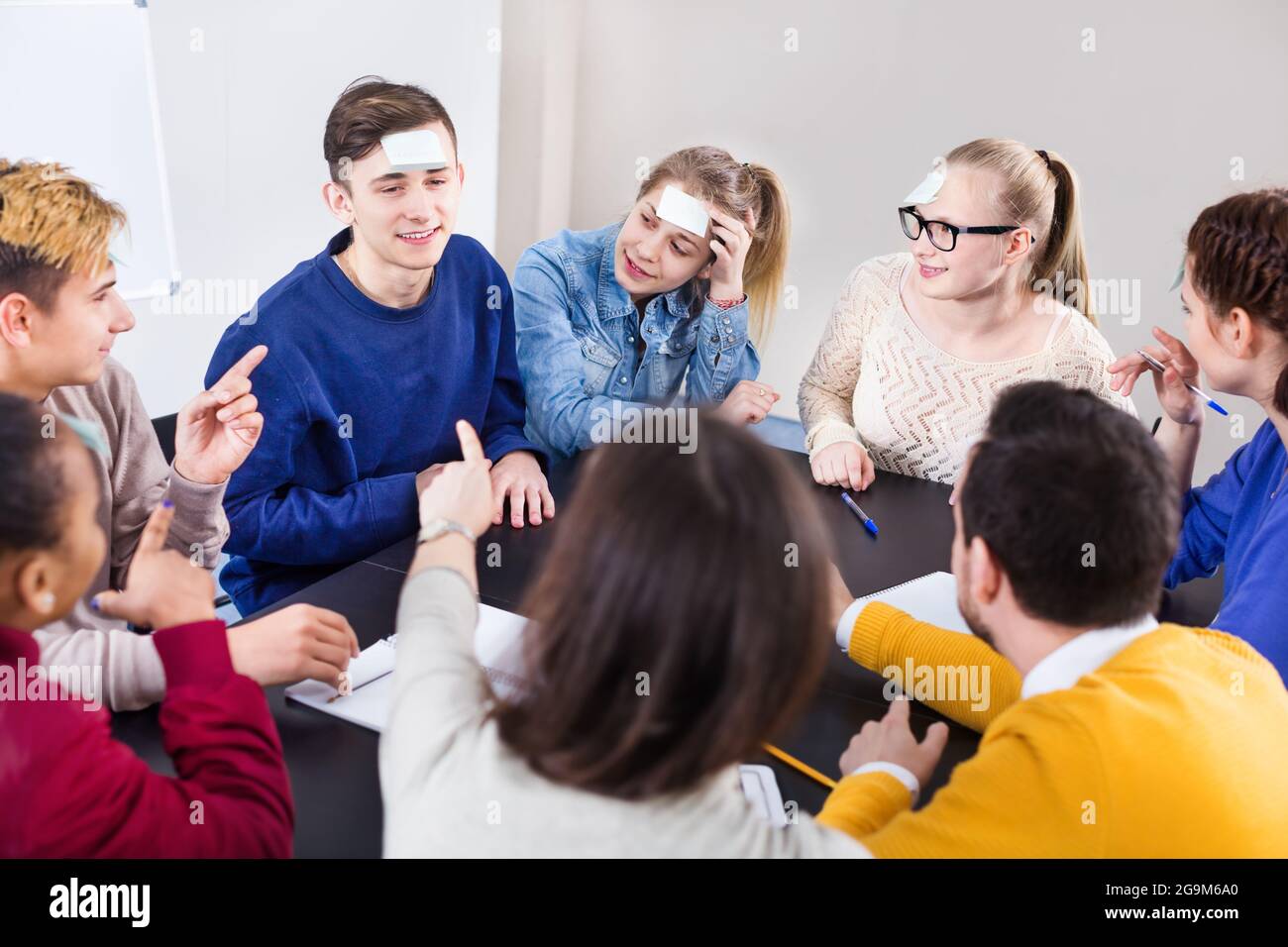 Fellow students playing a guess-who game during the school day Stock ...