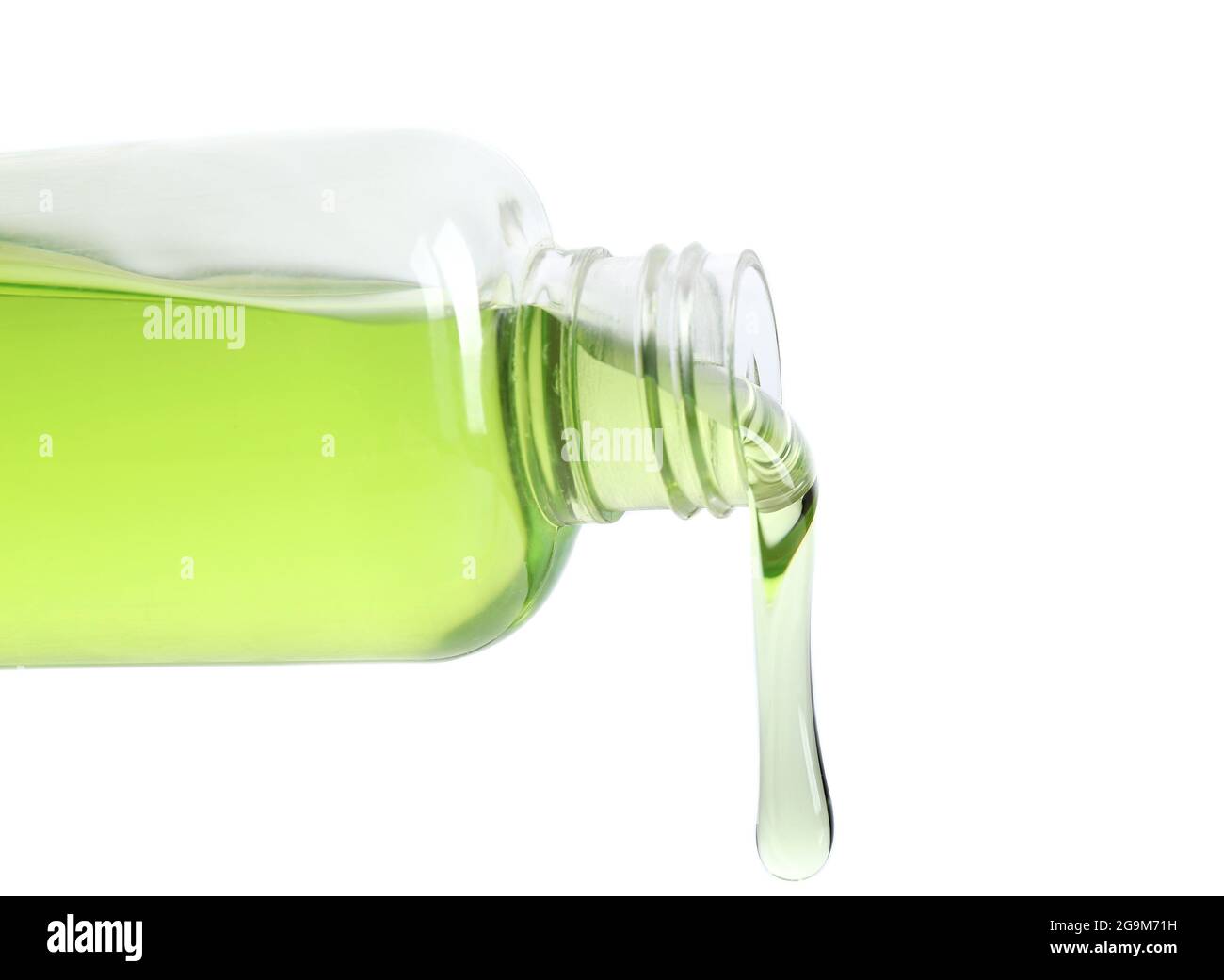 Cosmetic liquid pouring from bottle isolated on white Stock Photo - Alamy