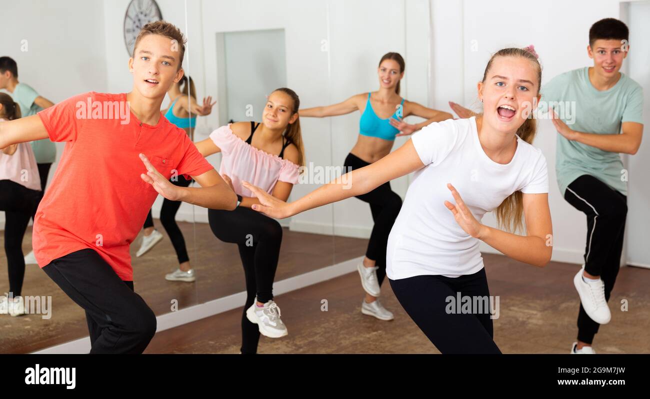 Group of teenagers training movements of modern dance in choreography ...