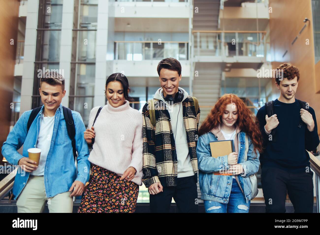 Young students going for their class. Group of young people walking ...