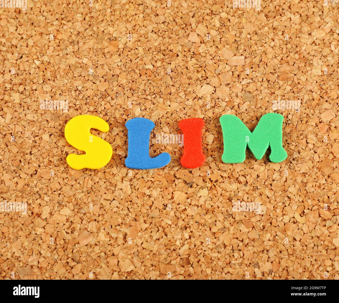 Slim word on cork board background Stock Photo - Alamy