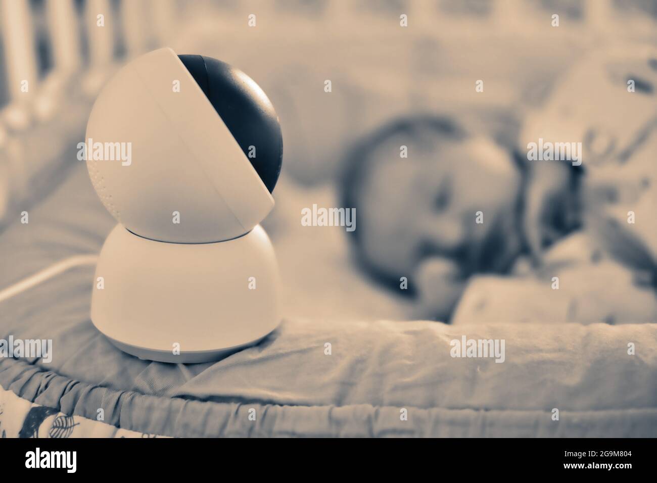 A home surveillance camera looks at the crib with a sleeping newborn ...