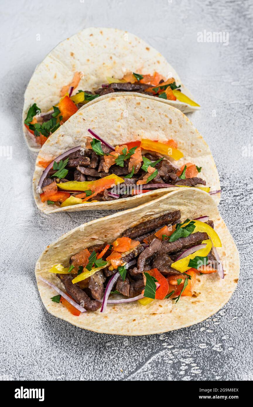 Mexican tacos with beef meat, onion and sweet pepper. White background ...
