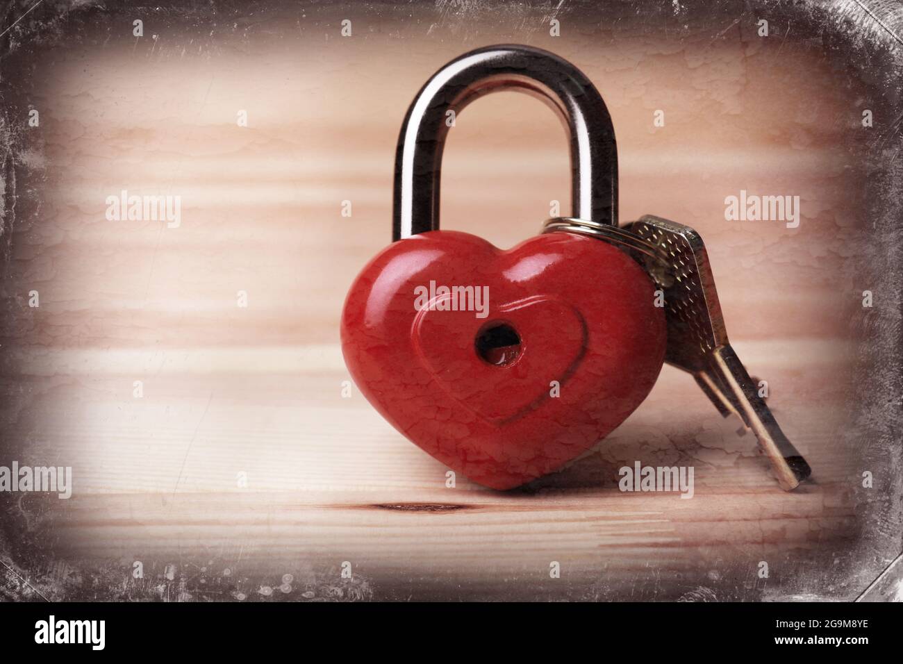Heart-shaped padlock with key on wooden background Stock Photo - Alamy