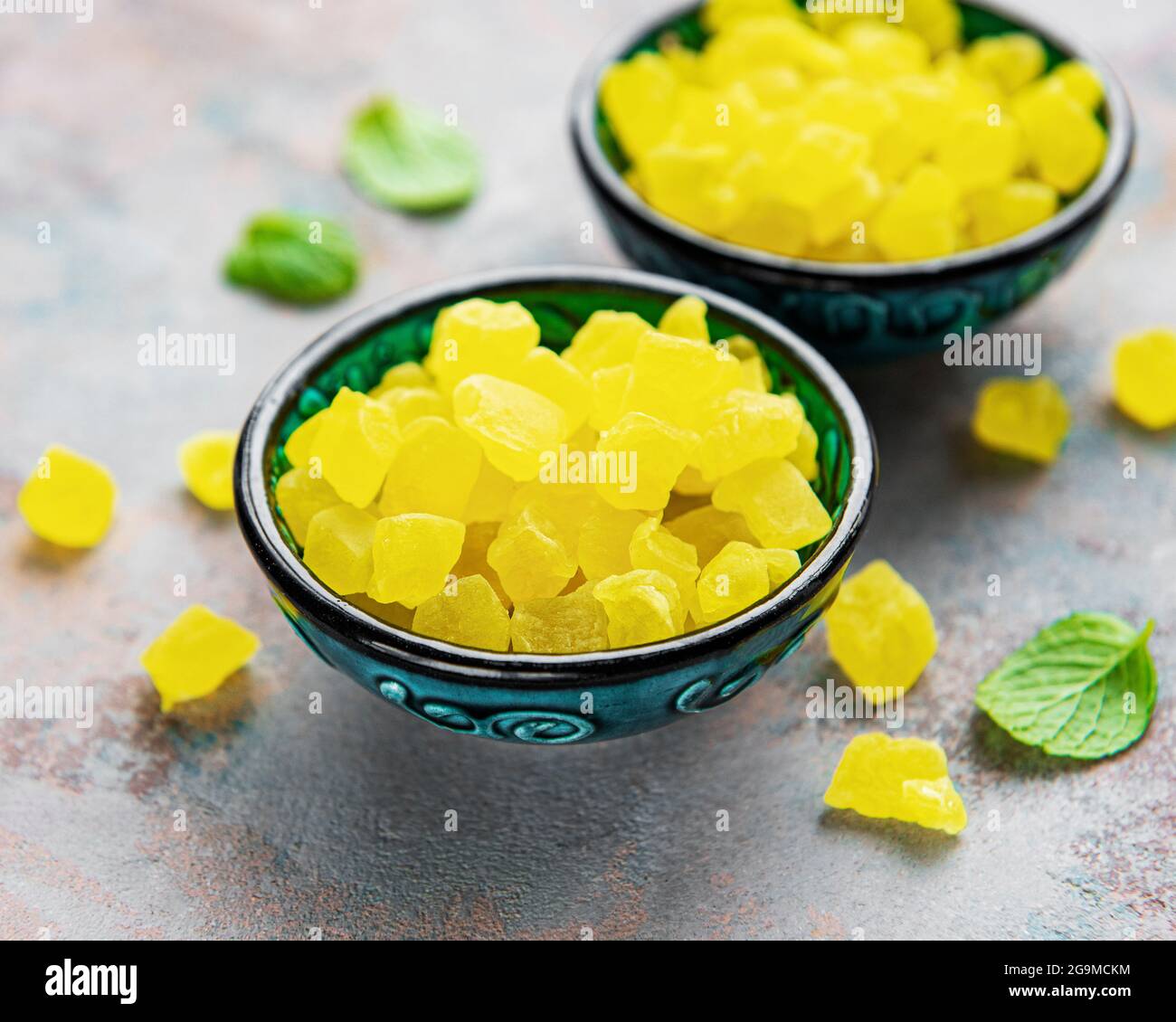 Sweet pineapple succade cubes on grey concrete background Stock Photo ...