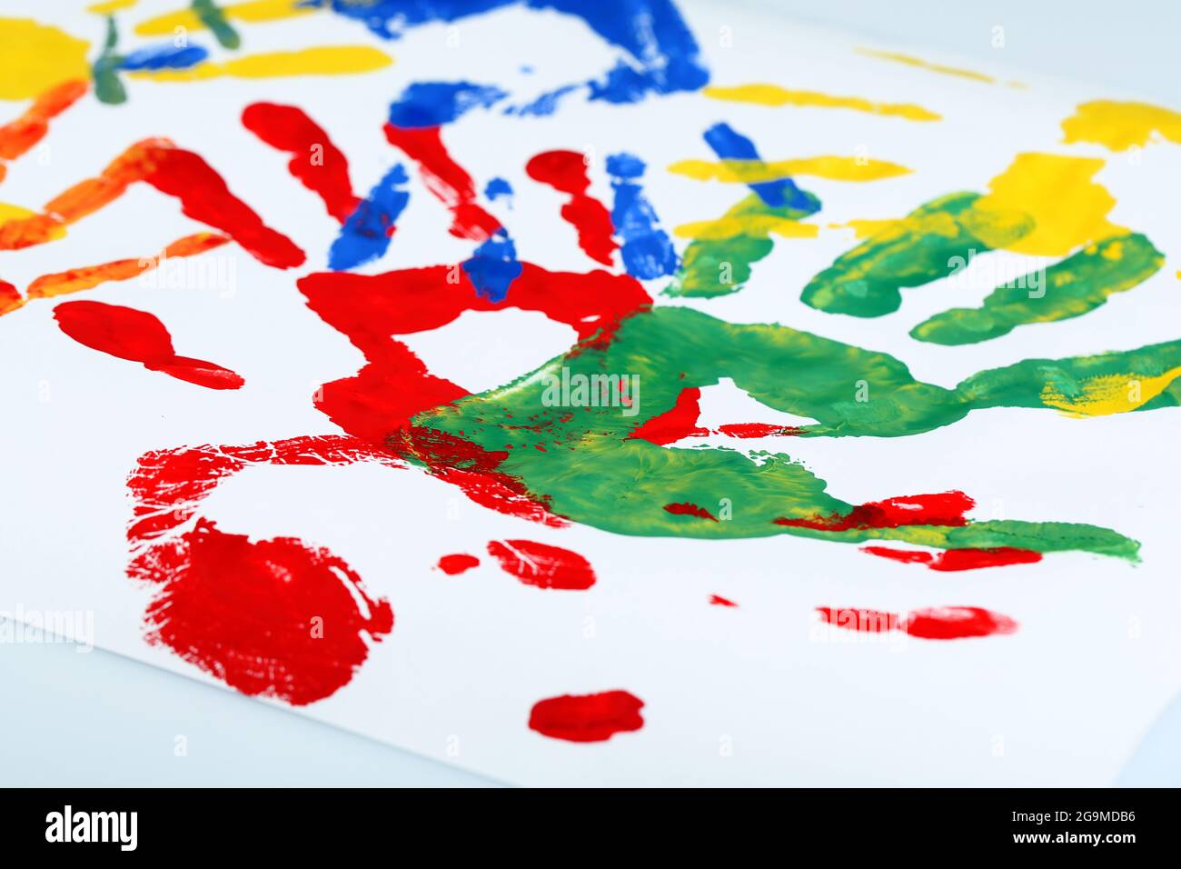 Hand prints of paint on white background Stock Photo - Alamy