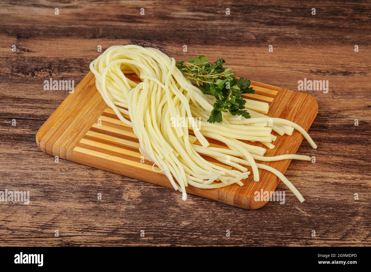 Chechil spaghetti cheese snack over board Stock Photo - Alamy