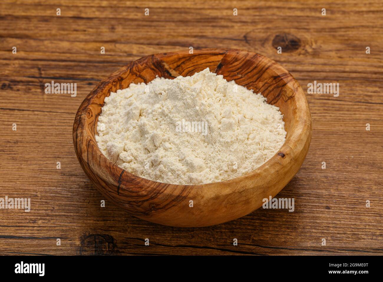 Wheat flour heap in the bowl for cooking Stock Photo - Alamy