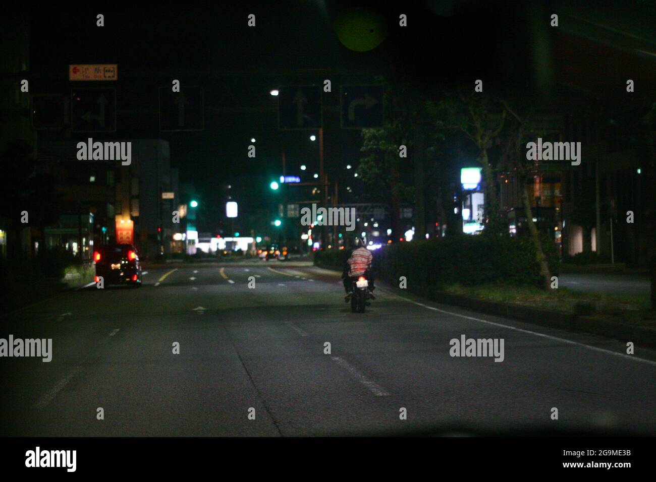 Two men Ride Motorcycle at Night - Japan Stock Photo - Alamy