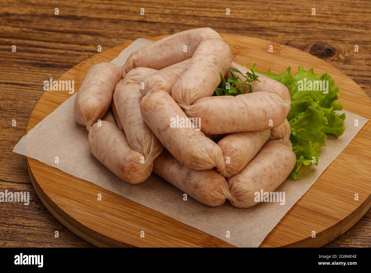 Raw natural chicken baby sausages for roast Stock Photo - Alamy