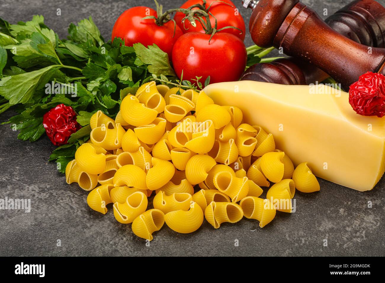 Italian pasta - raw pipe rigate served vegetables Stock Photo - Alamy