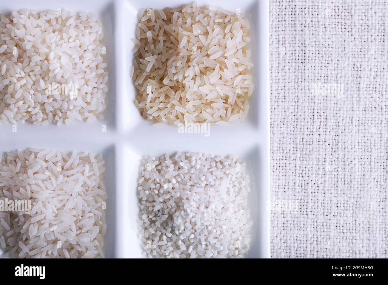 Different types of rice on plate on fabric background Stock Photo - Alamy
