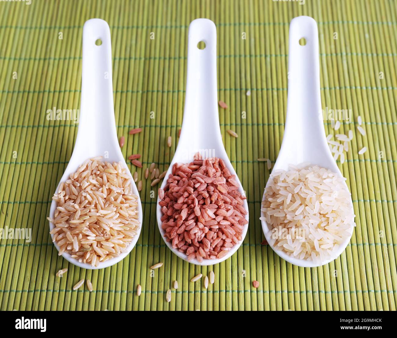 Different types of rice in spoons on bamboo background Stock Photo - Alamy