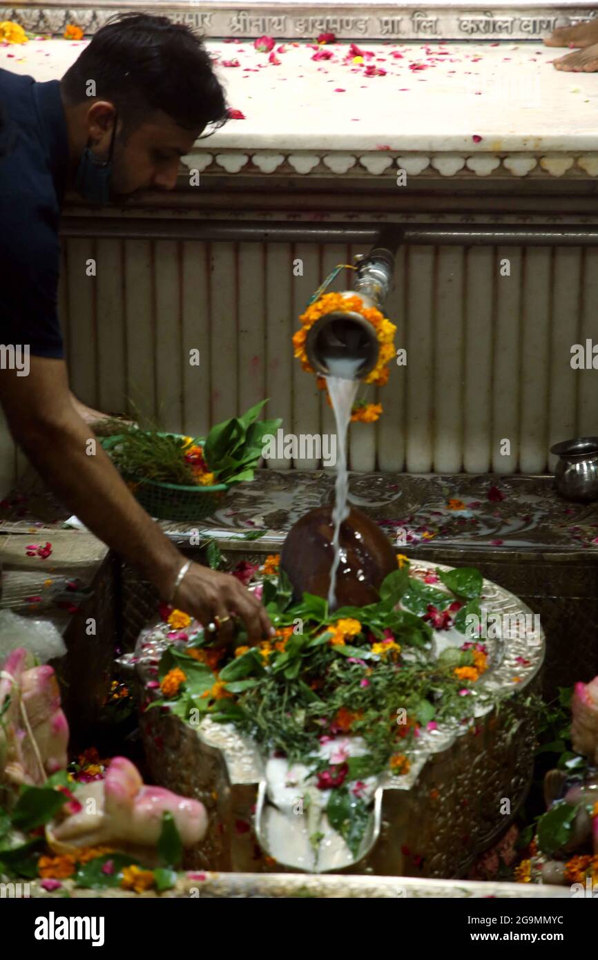 Devotees stand in queue with Jal and fruit thali an offering for ...