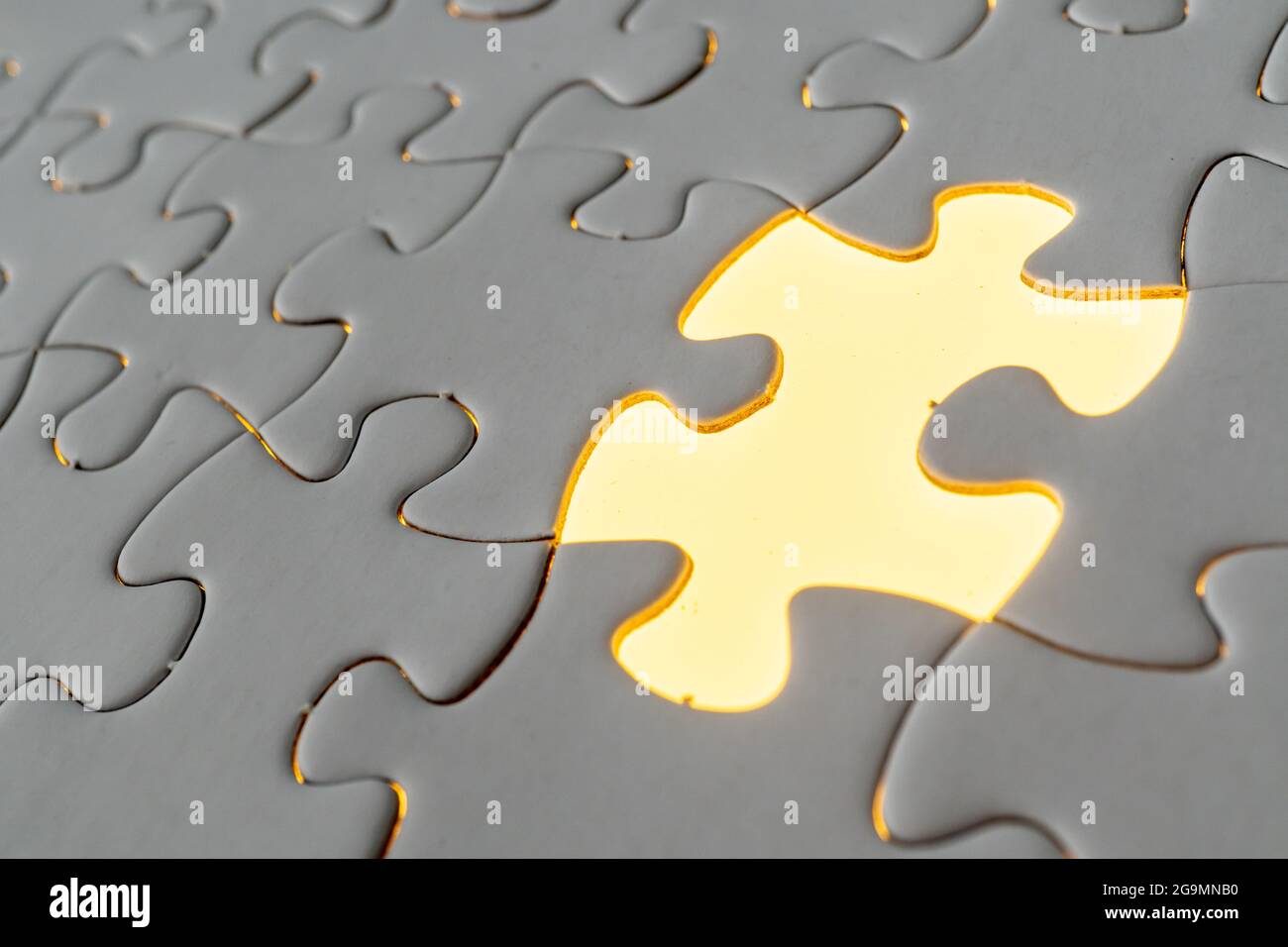 Closeup of a gray jigsaw puzzle with a missing piece Stock Photo - Alamy