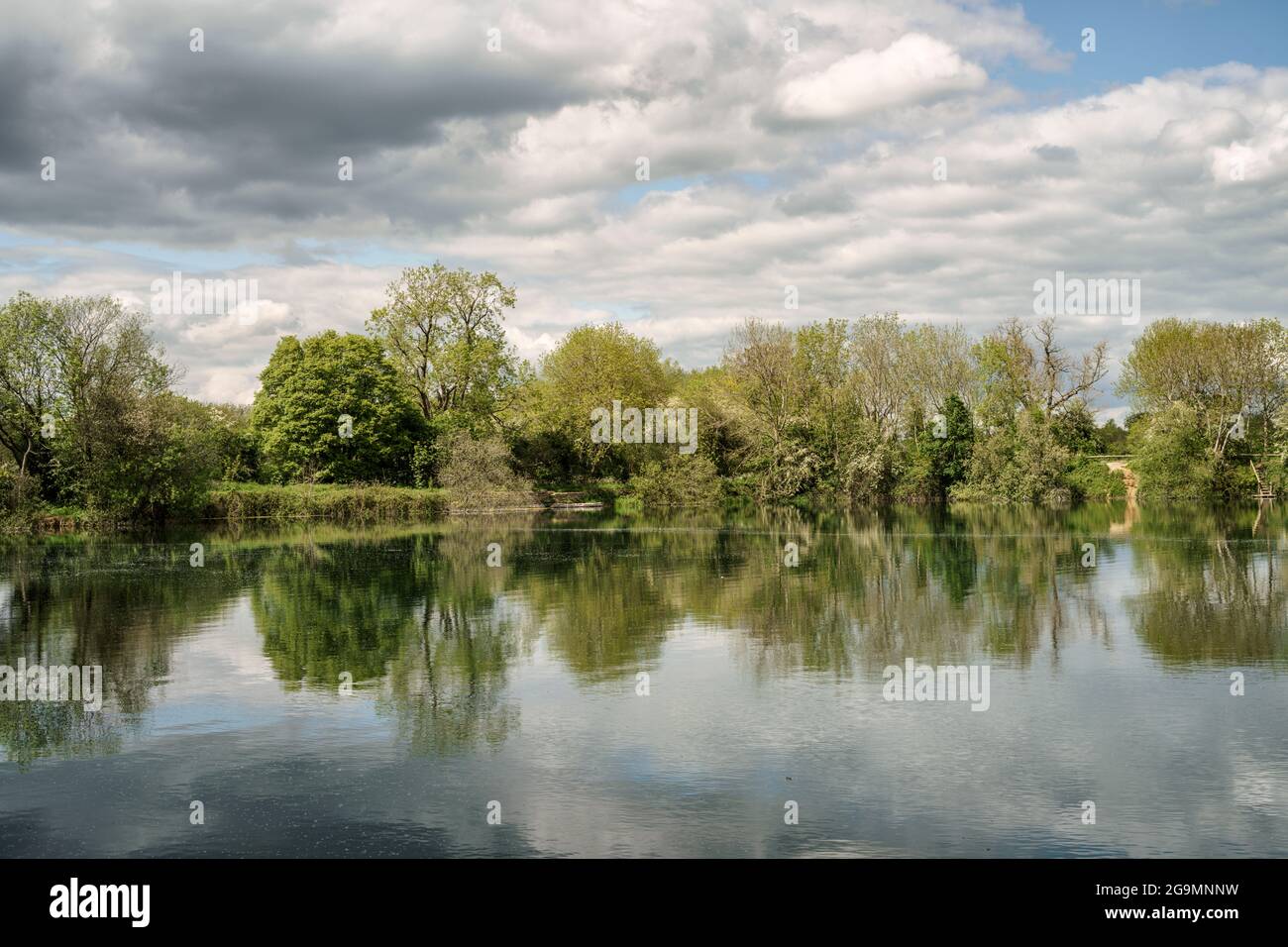 View across the lake at Neighbridge Country Park in the Cotswold Water ...