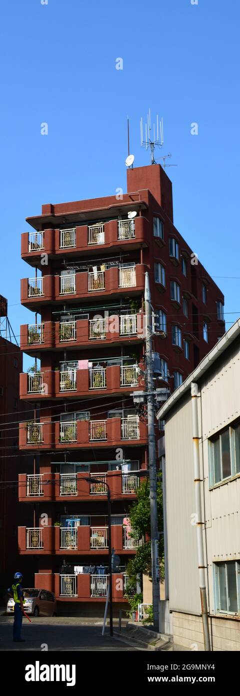TOKYO, JAPAN - Sep 08, 2017: A vertical shot of a red narrow apartment ...