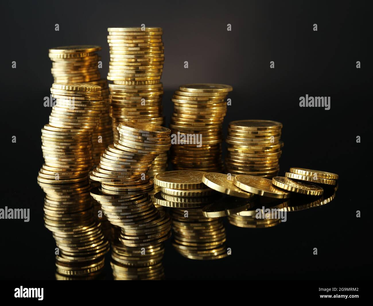 Pile of coins on dark background Stock Photo - Alamy