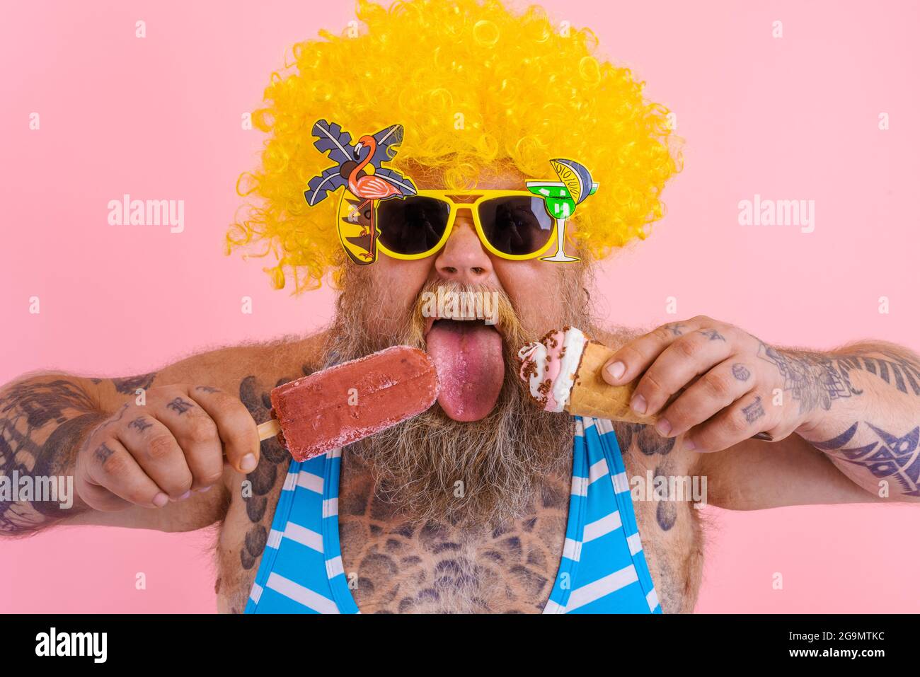 Fat man with beard and wig eats a popsicle and an icecream Stock Photo ...
