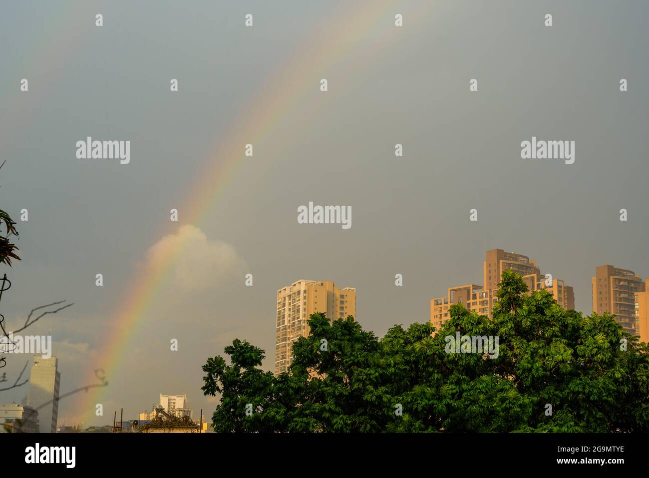 A double rainbow appeared over the city after the rain Stock Photo - Alamy