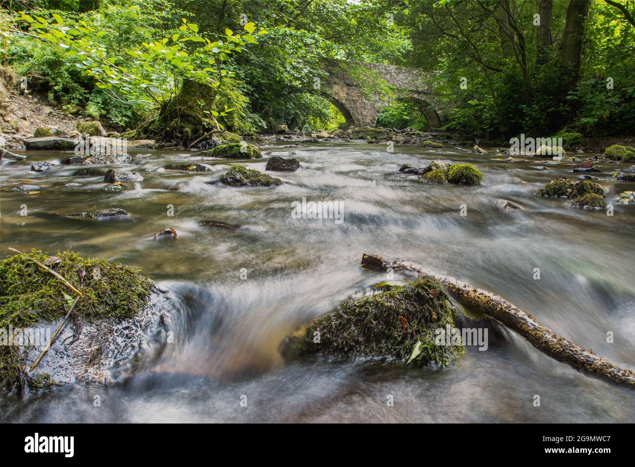 Rushing water under a bridge Stock Photo - Alamy