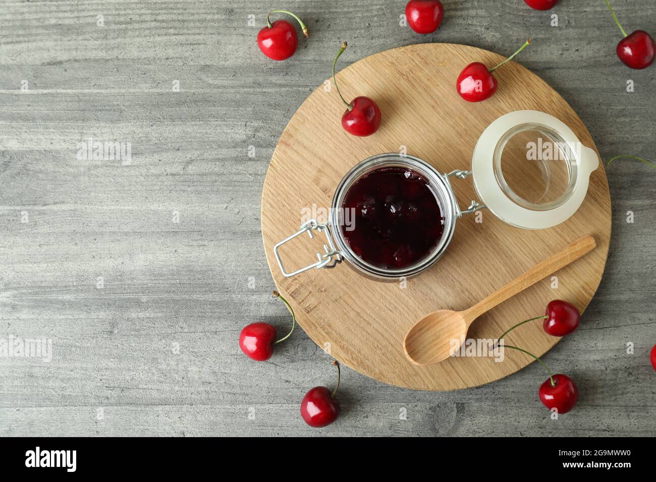 Cherry jam and ingredients on gray textured table Stock Photo - Alamy