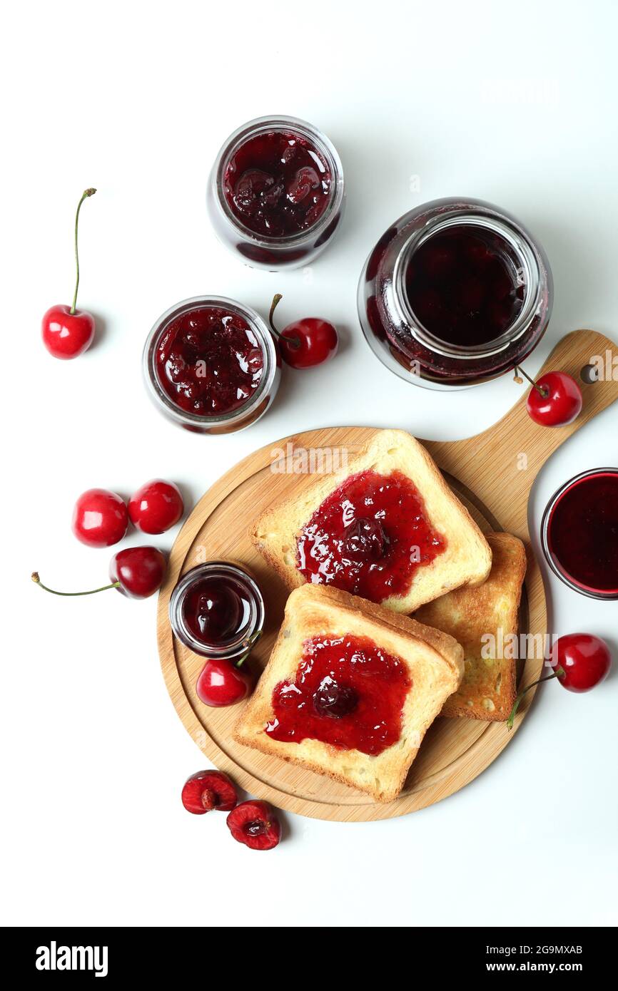Cherry jam sandwiches and ingredients on white background Stock Photo ...