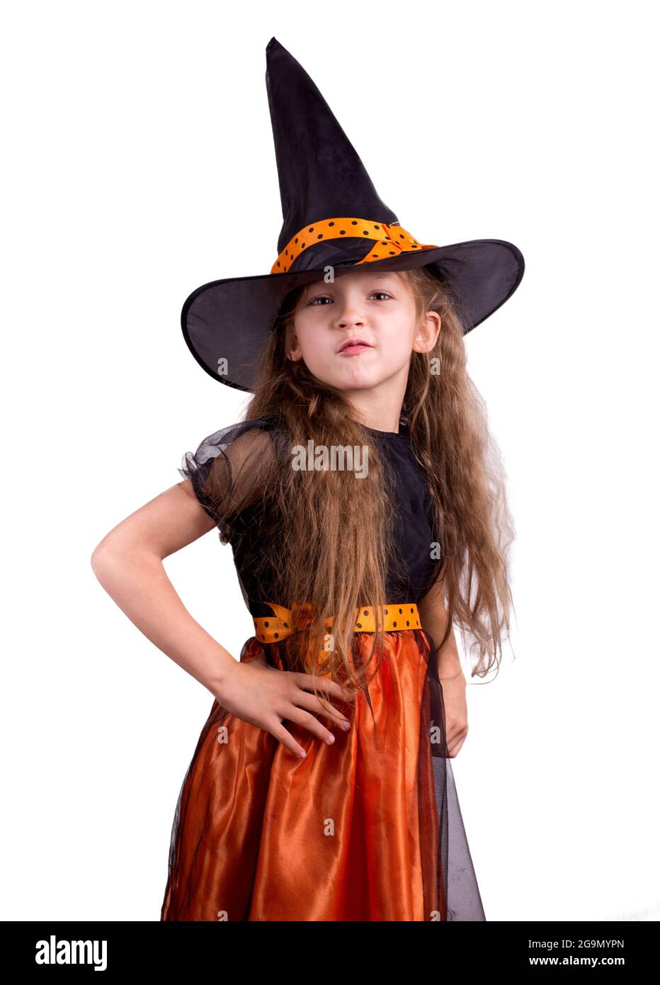 Happy laughing little girl wearing a witch carnival costume playing ...