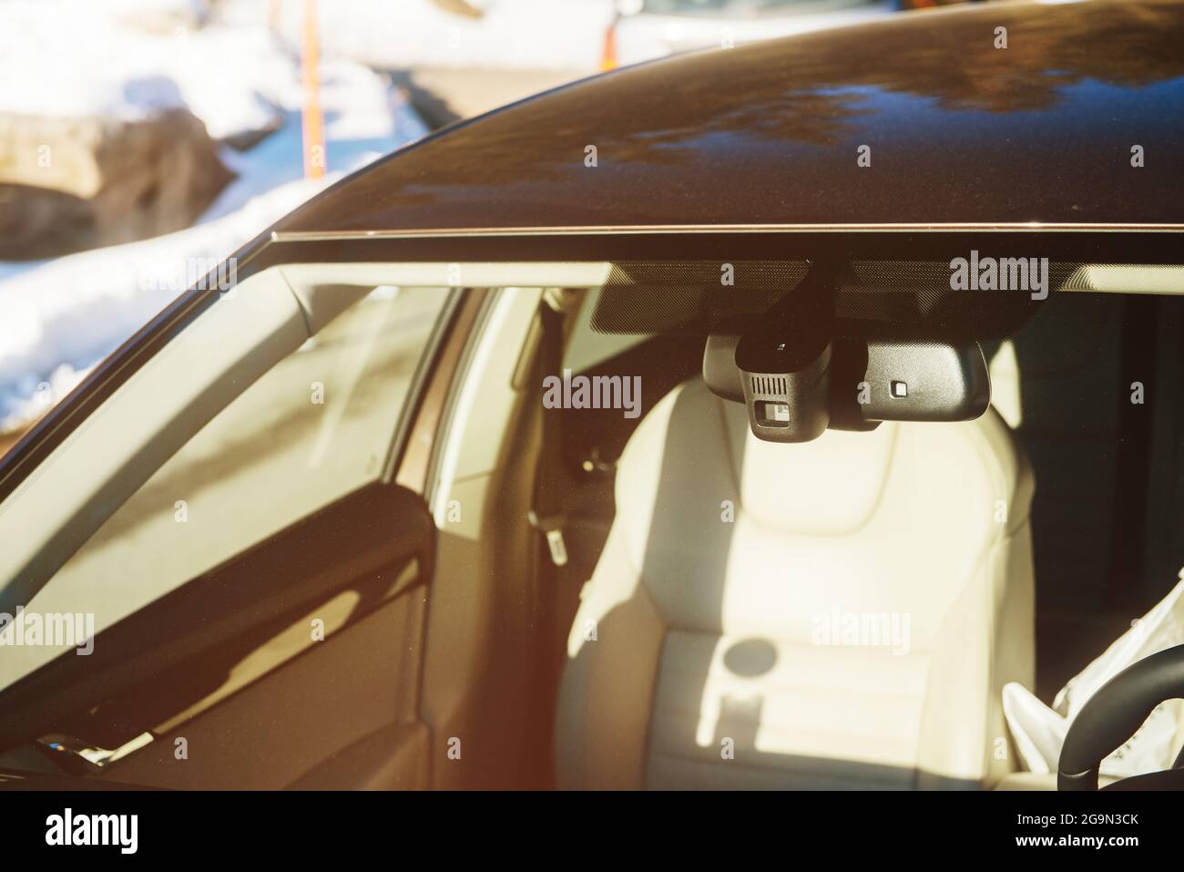 Close-up of new car with sensor on the rear view mirror for the Lights ...
