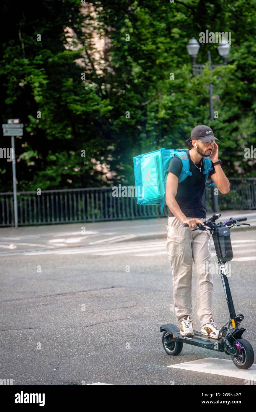 Deliveroo driver on scooter driving fast to deliver the internet Stock ...