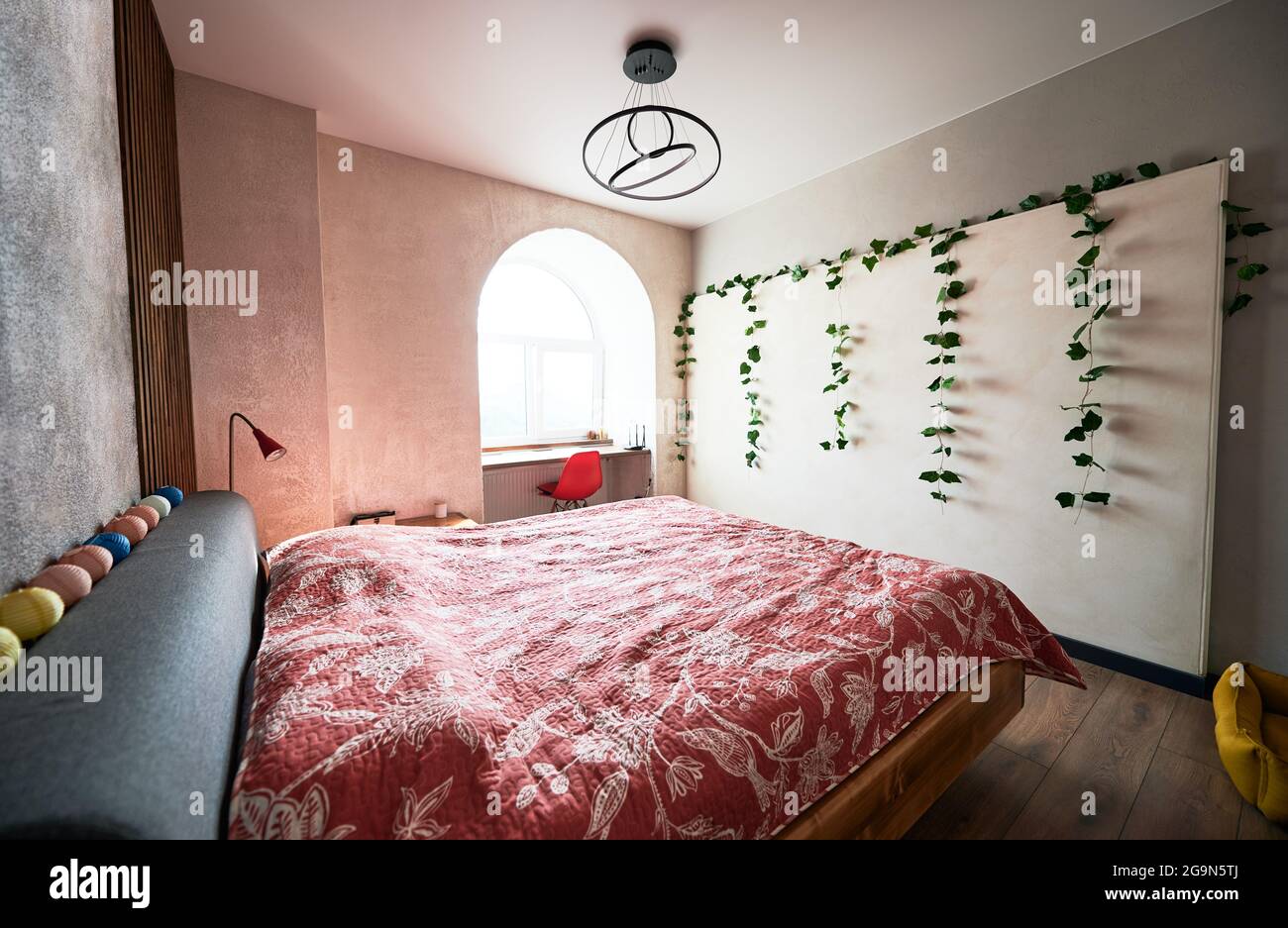 Side view of bright bedroom with modern furniture and trendy lamps and ...