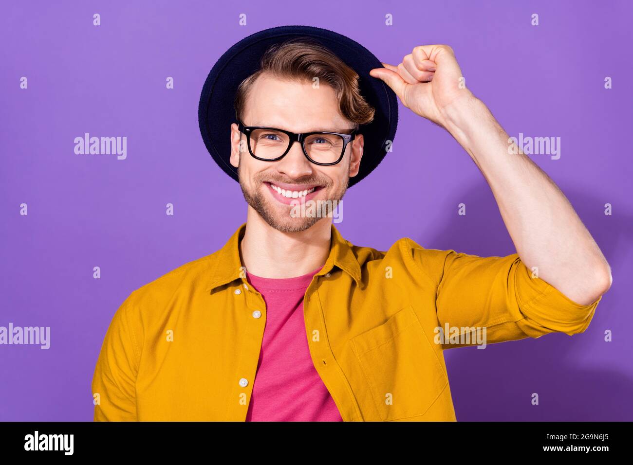 Photo of attractive young positive hipster man wear hat smile glasses ...