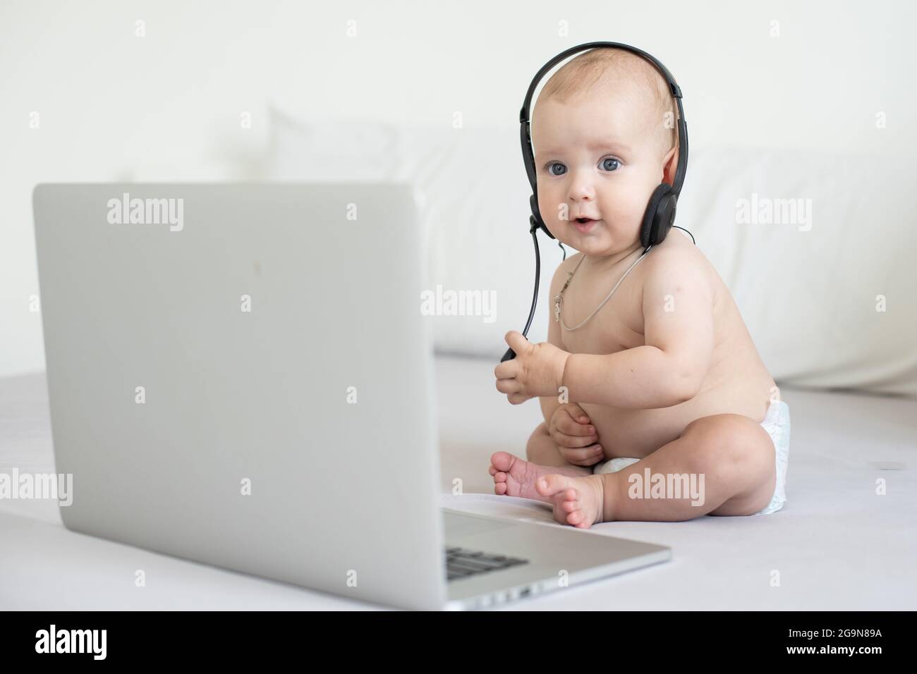 Baby with laptop on the white background Stock Photo - Alamy