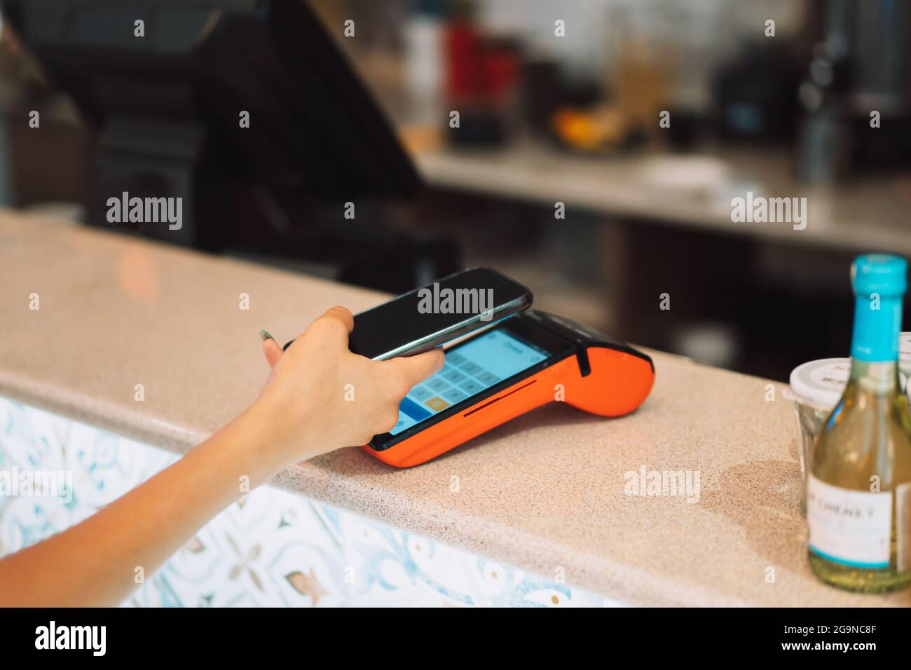 Contactless payment from the phone through the pos terminal Stock Photo ...