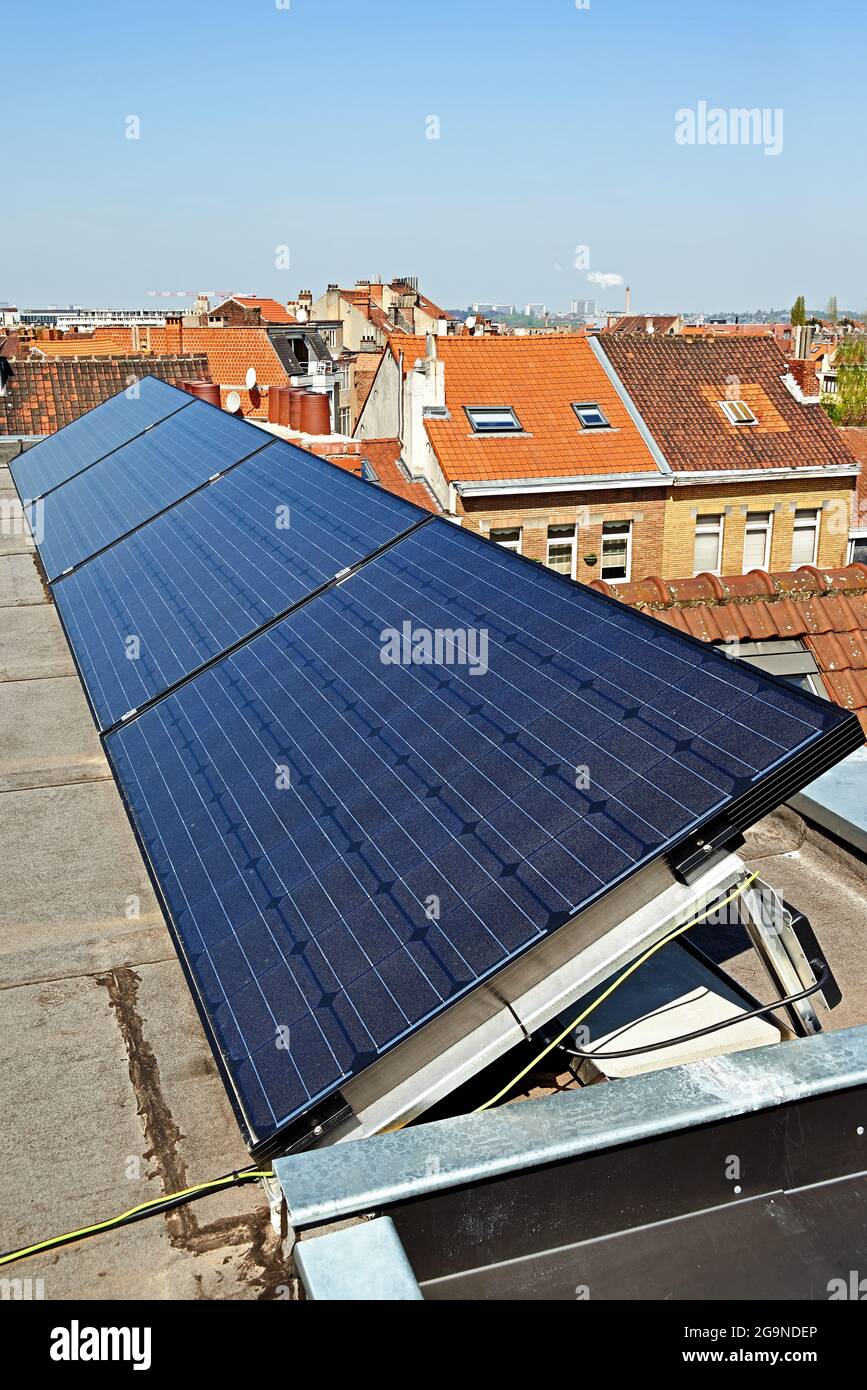 Large electric solar panels on roof in sunrise with clear blue sky ...