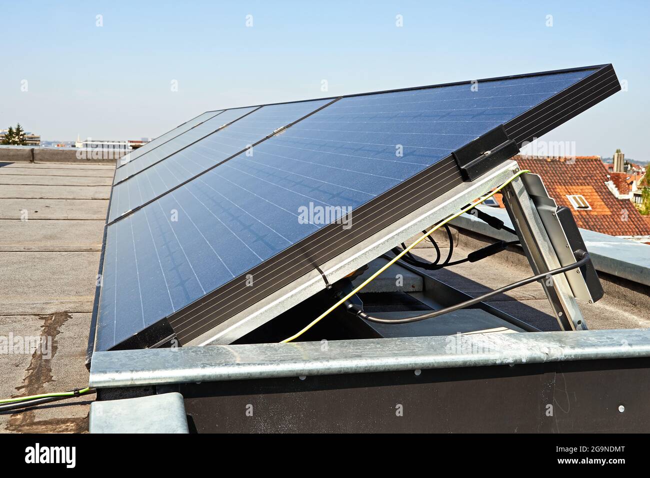 Large electric solar panels on roof in sunrise with clear blue sky ...