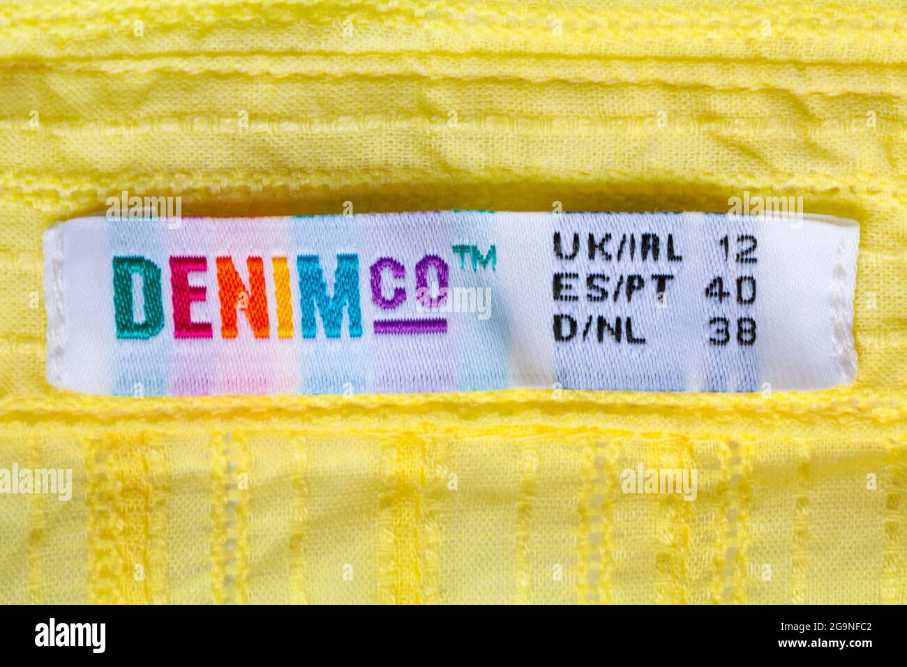 Denim Co label in woman's yellow blouse shirt - Denim Co logo Stock ...
