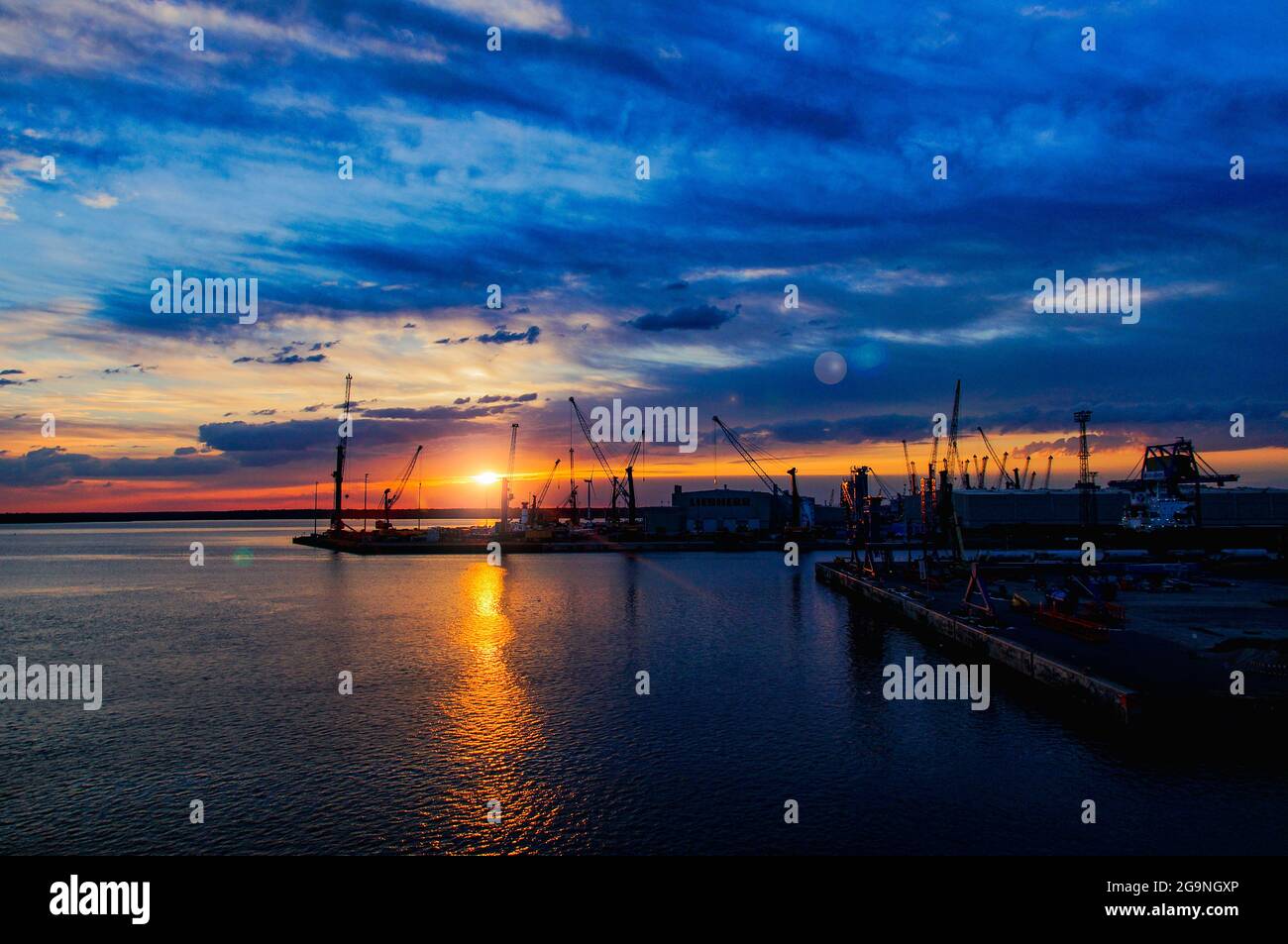Beautiful bright sunset over a port Stock Photo - Alamy
